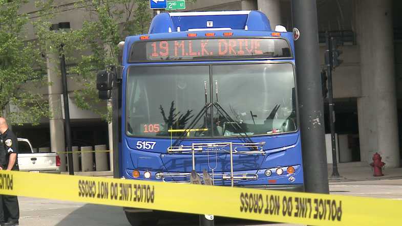 Woman hit, pinned under bus