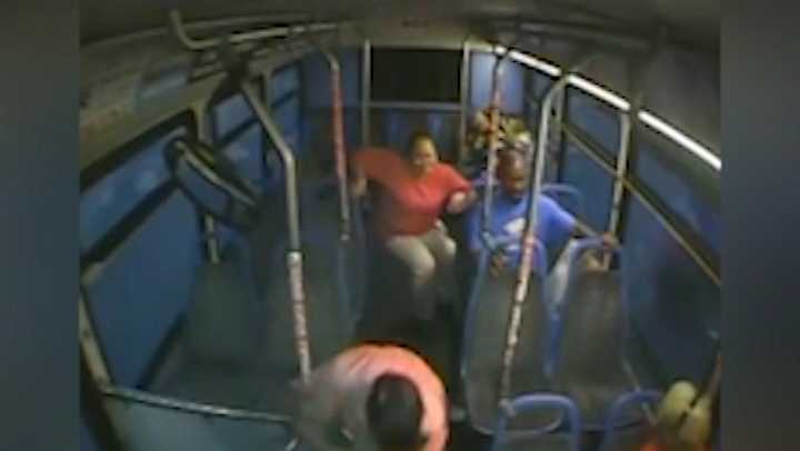 Driver runs red light and collides with bus full of people