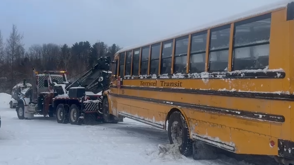School bus carrying 10 students flips on its side during whiteout ...