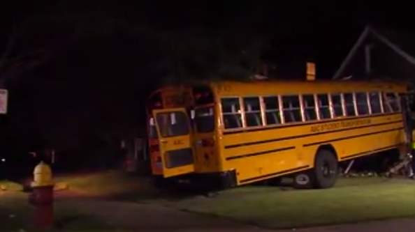 School bus crashes into home