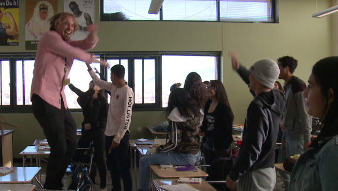 Teacher does motivational raps for students