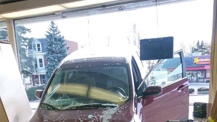 Car smashes through store window