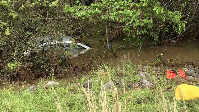 Woman drowns when flood water sweeps car into creek