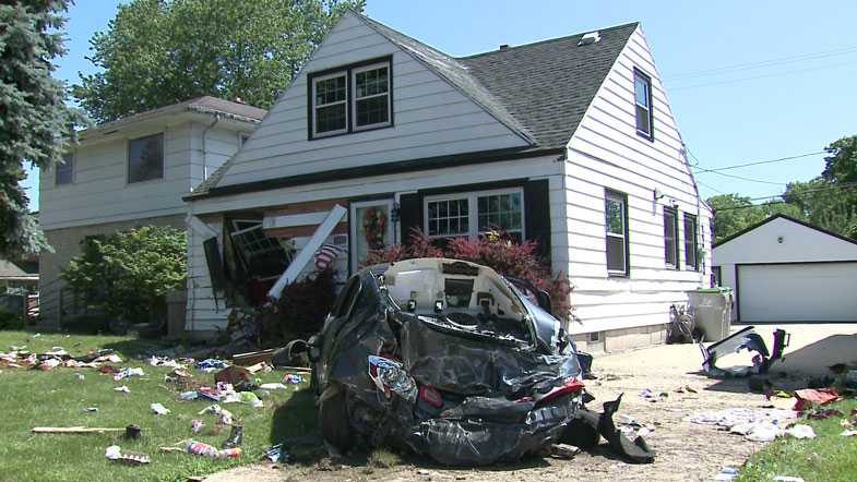 2 injured as car smashes into home