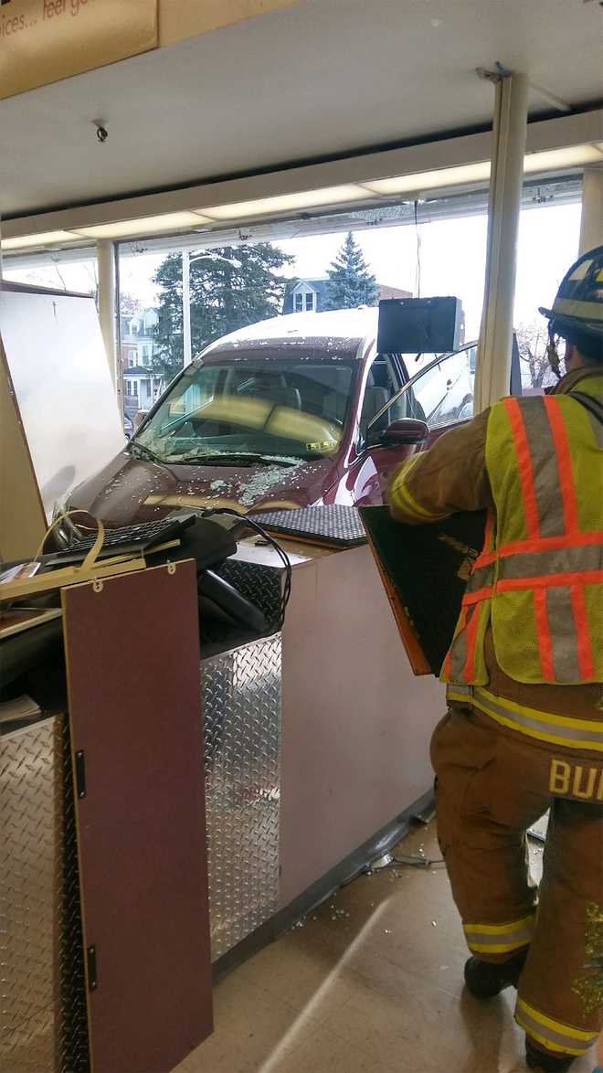 Car smashes through store window
