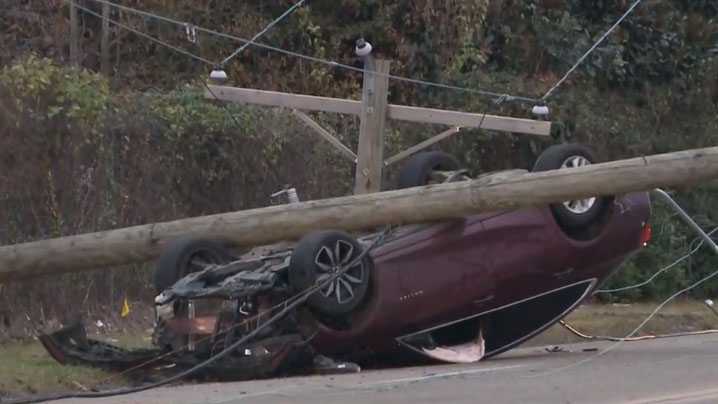 Car overturns, crashes into power pole