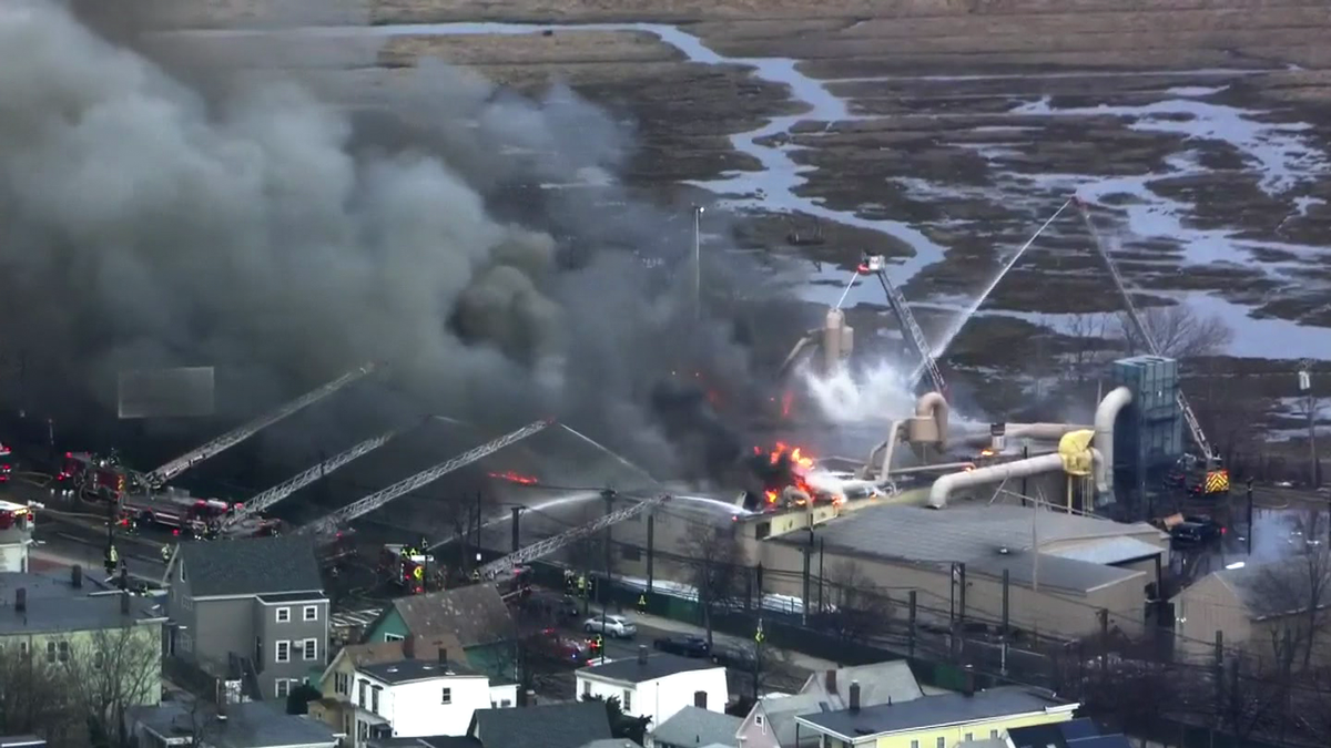 Raging fire at East Boston business prompts evacuations, MBTA disruption