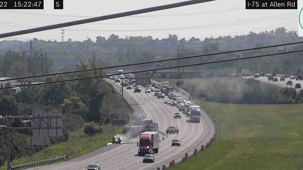 A vehicle on fire is blocking several lanes along I-75
