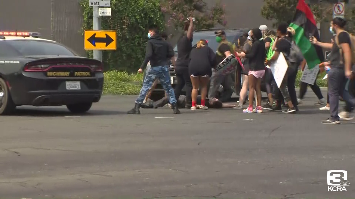 Protester climbs on top of CHP car, is thrown from vehicle