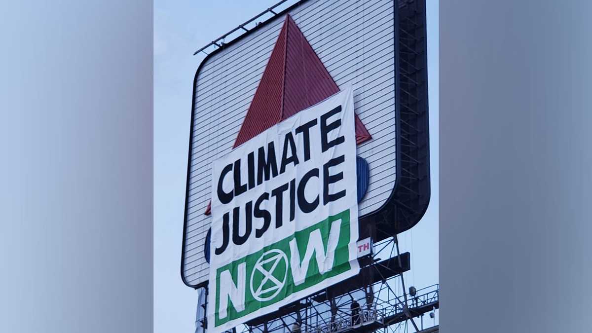 'Climate Justice Now' banner hung over Boston's Citgo sign
