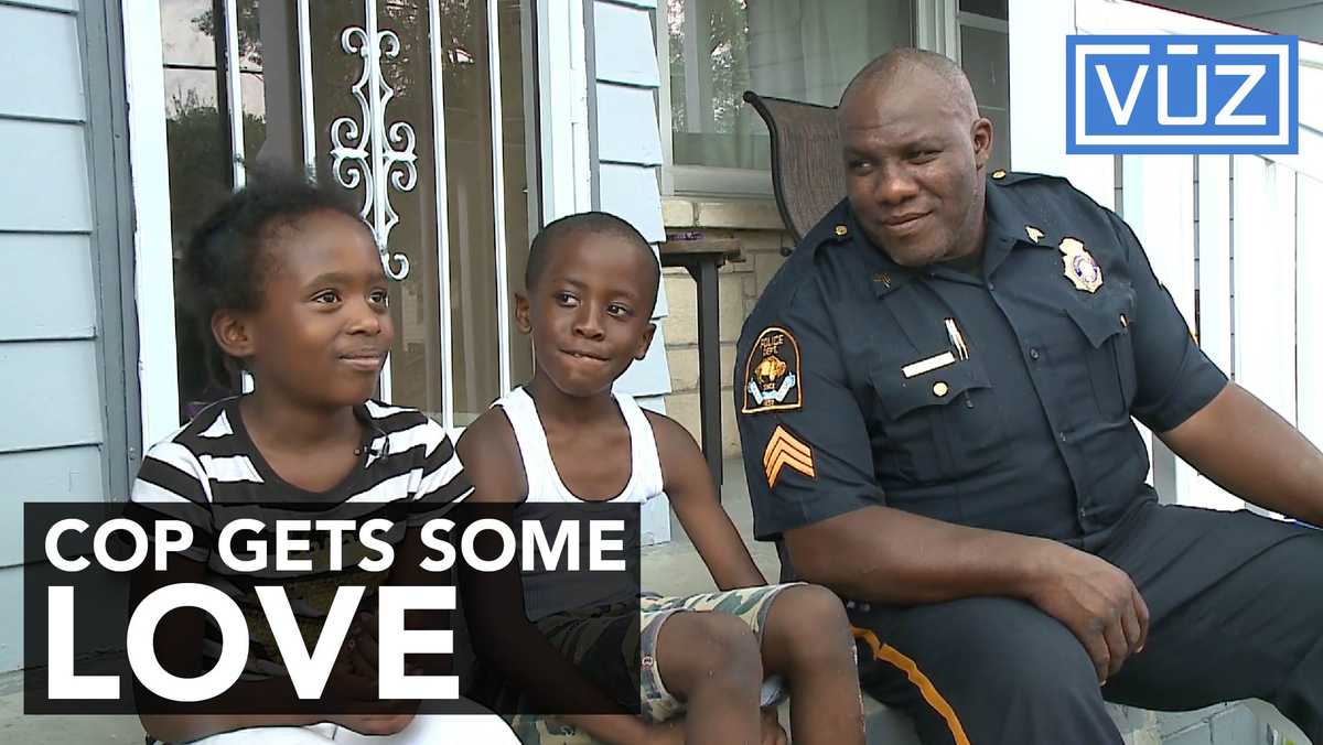 Two young artists make a neighborhood cop's day