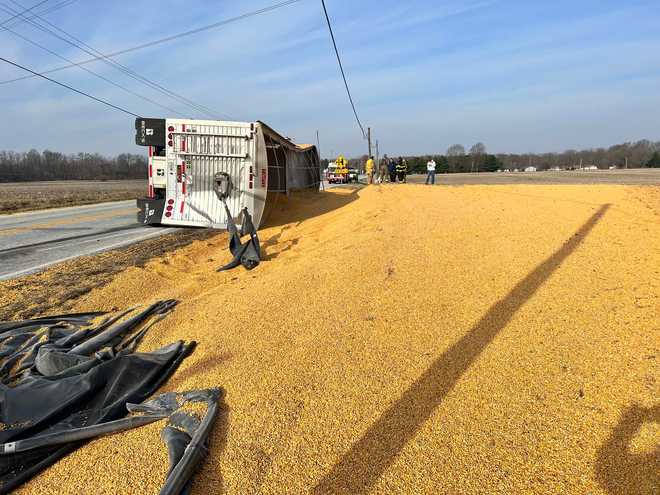 Tractor-trailer overturns, spilling large amount of corn along highway ...
