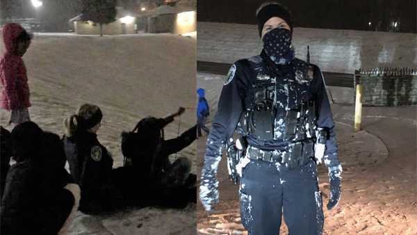 Covington police officers join children sledding in snow