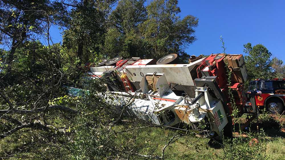 Crane overturns after driver loses control in curve, officials say