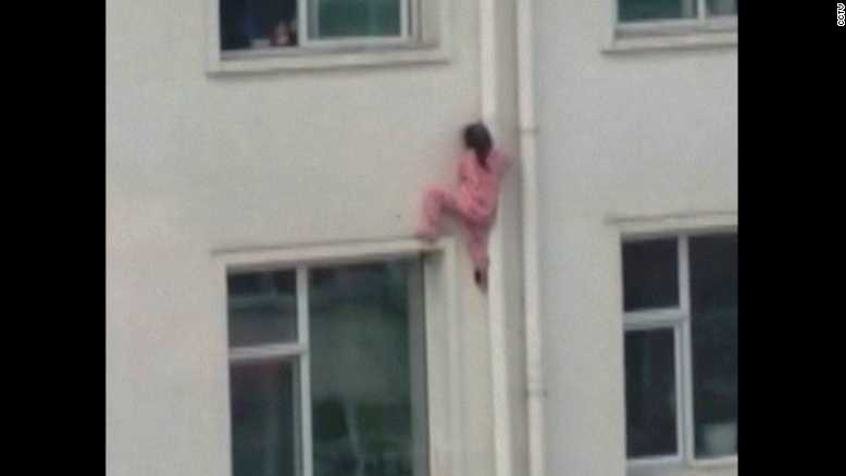 6-year-old girl found dangling from high-rise ledge