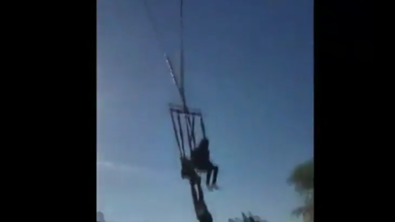 Woman falls from ride, dangles until rescued