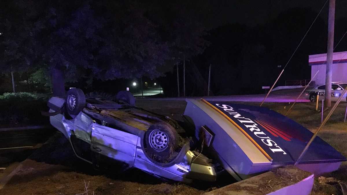 Car crashes into SunTrust Bank sign, flips