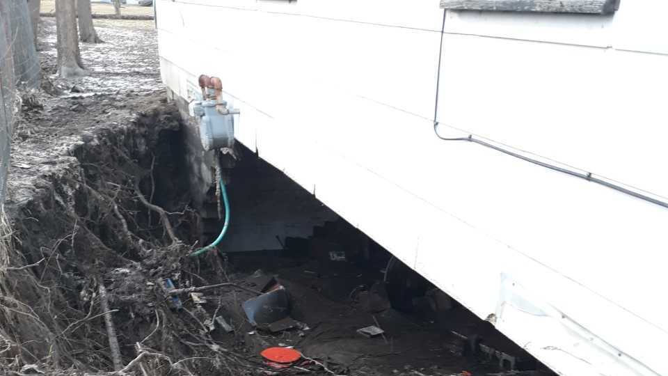 Flooding aftermath: damage to homes, roads