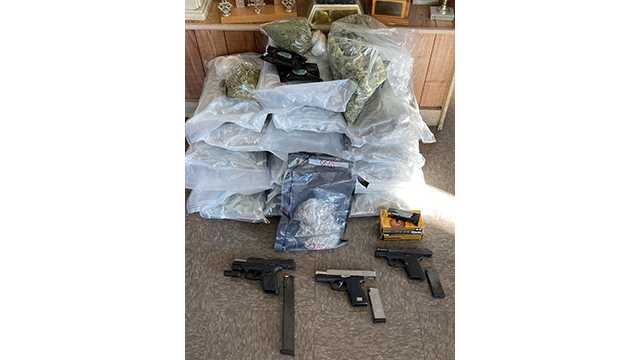 Police collect drugs, guns, cash in drug seizure