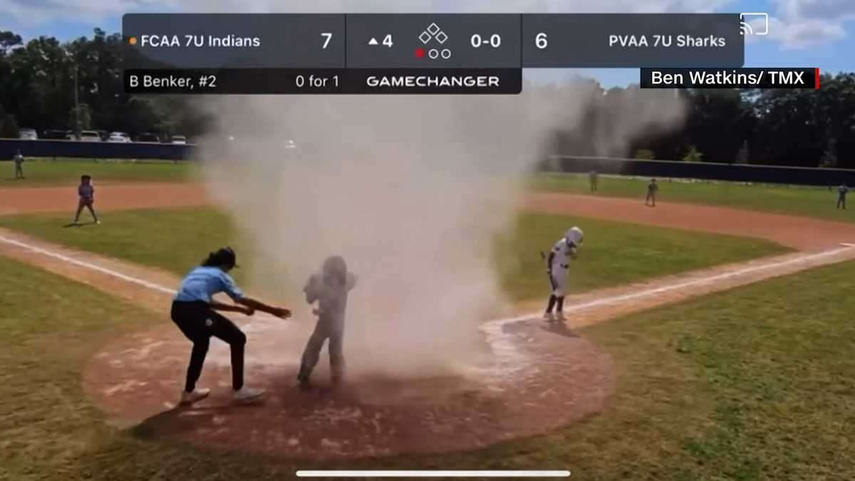 Dust devil briefly envelops 7-year-old at baseball game