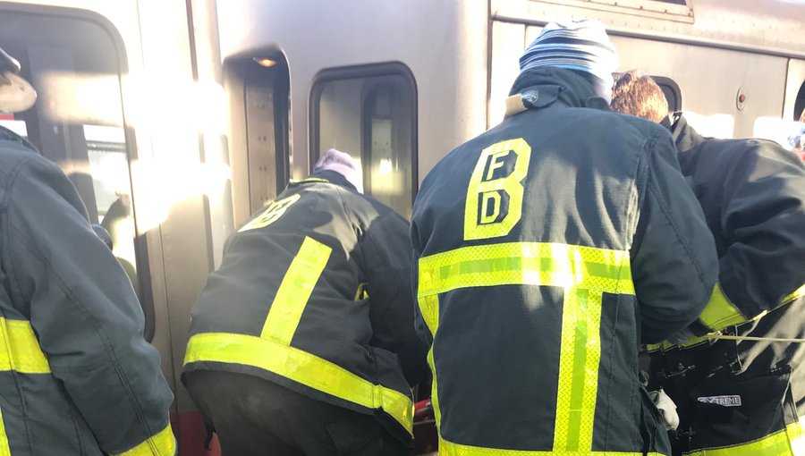 Firefighters free man trapped under Red Line train