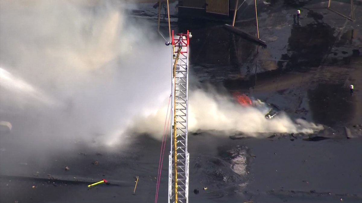 Raging fire at East Boston business prompts evacuations, MBTA disruption