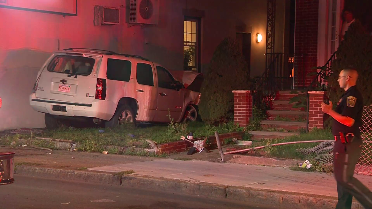 SUV hits building in Everett after crash