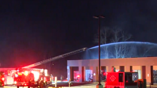 Flames rekindle 24 hours after fire broke out at storage facility in ...