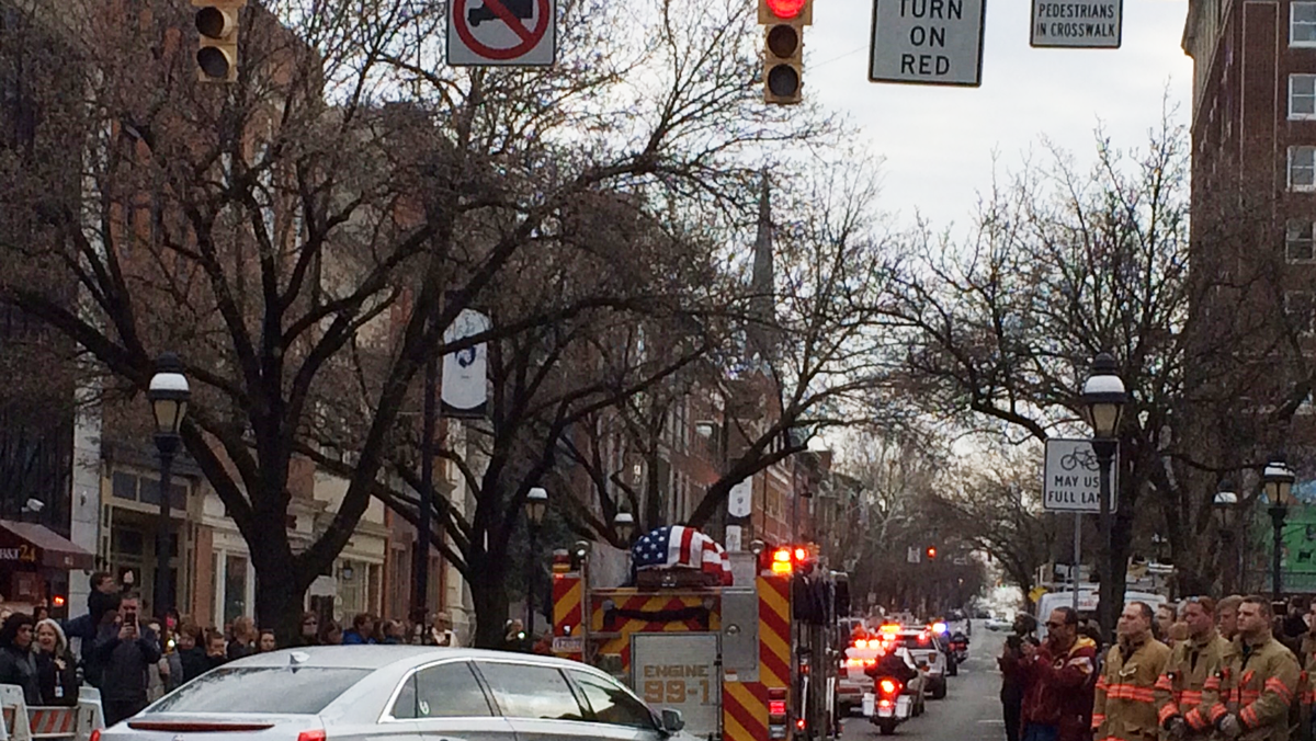 Firetruck carries casket through York streets