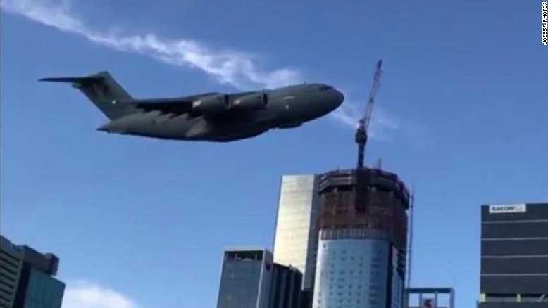 Massive military jet does low flyover through city