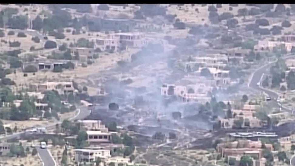 Fire burns dangerously close to homes in Foothills