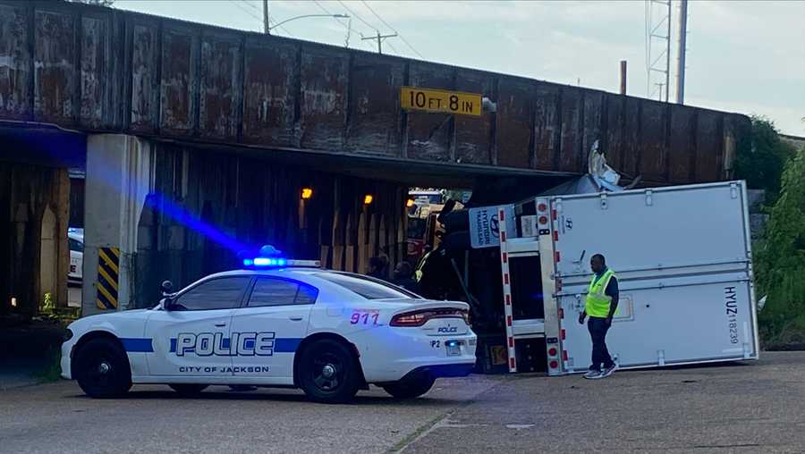 Tractor-trailer stuck under bridge near downtown Jackson