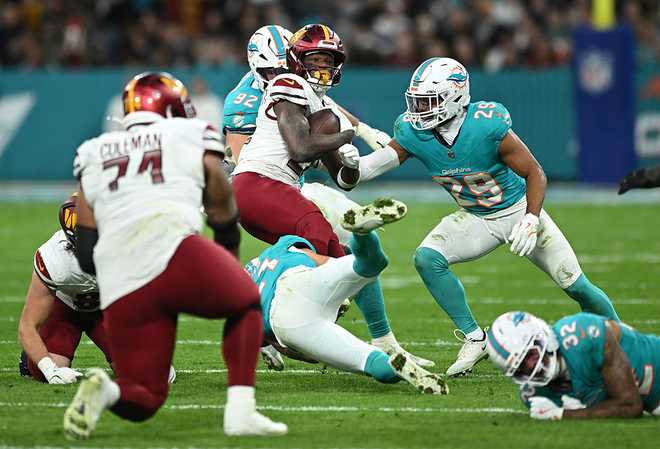 Dolphins beat Commanders in overtime in first NFL regular-season game ...