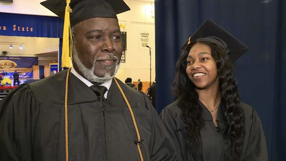 Father and daughter walk together at community college graduation