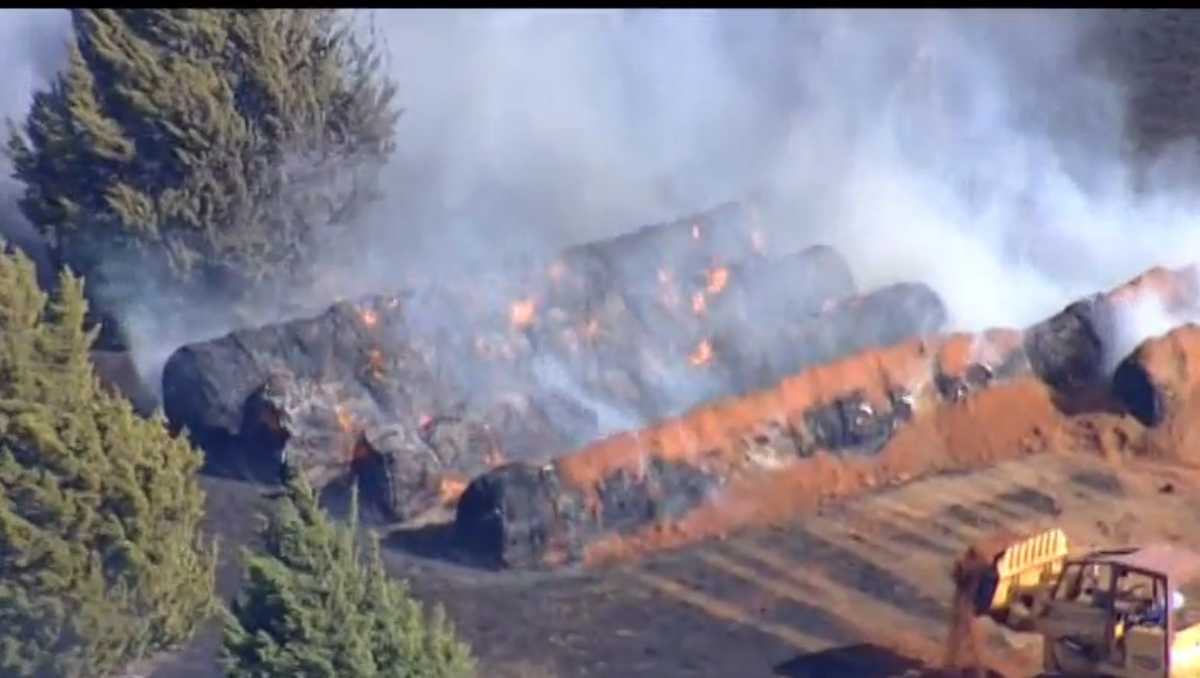 Firefighters battle grass, hay bale fire in Guthrie