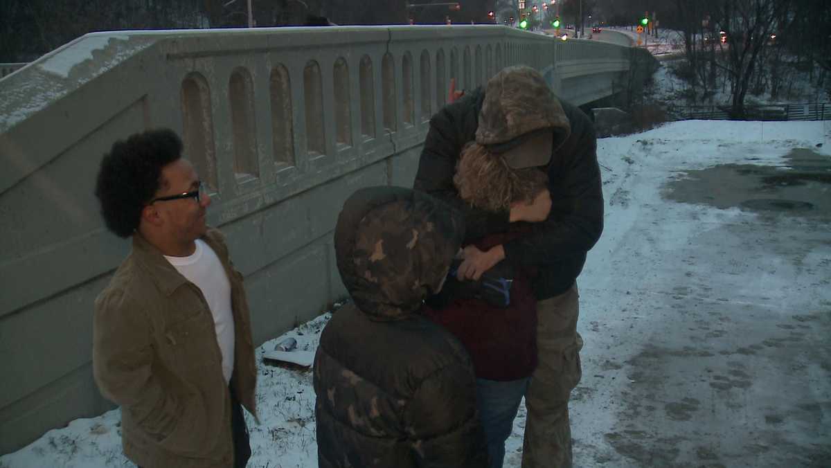 Woman lends a helping hand to homeless man in need.