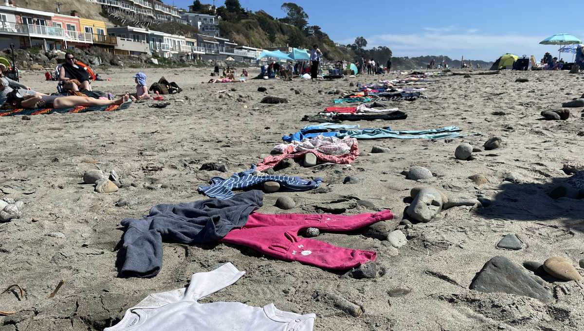 Thousands of children's clothes laid along California beach in support ...