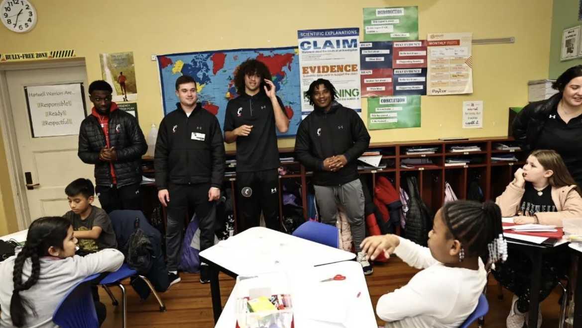 PHOTOS: UC football players spend time with students at Hartwell Elementary