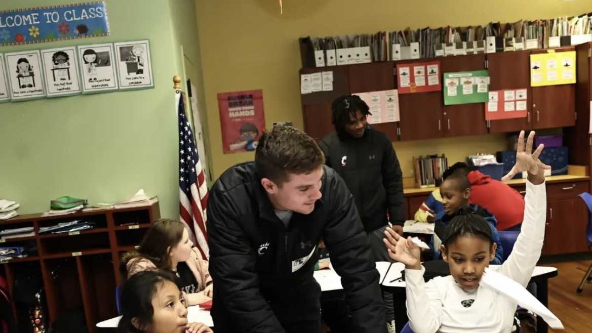 PHOTOS: UC football players spend time with students at Hartwell Elementary