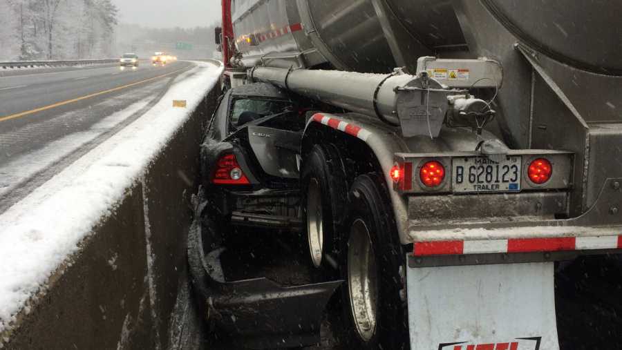 Driver escapes injury after car gets pinned, crushed under tanker