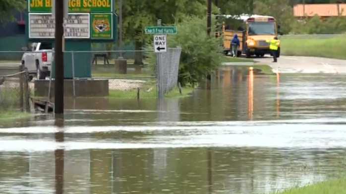School buses maneuver around flooding to pick up students