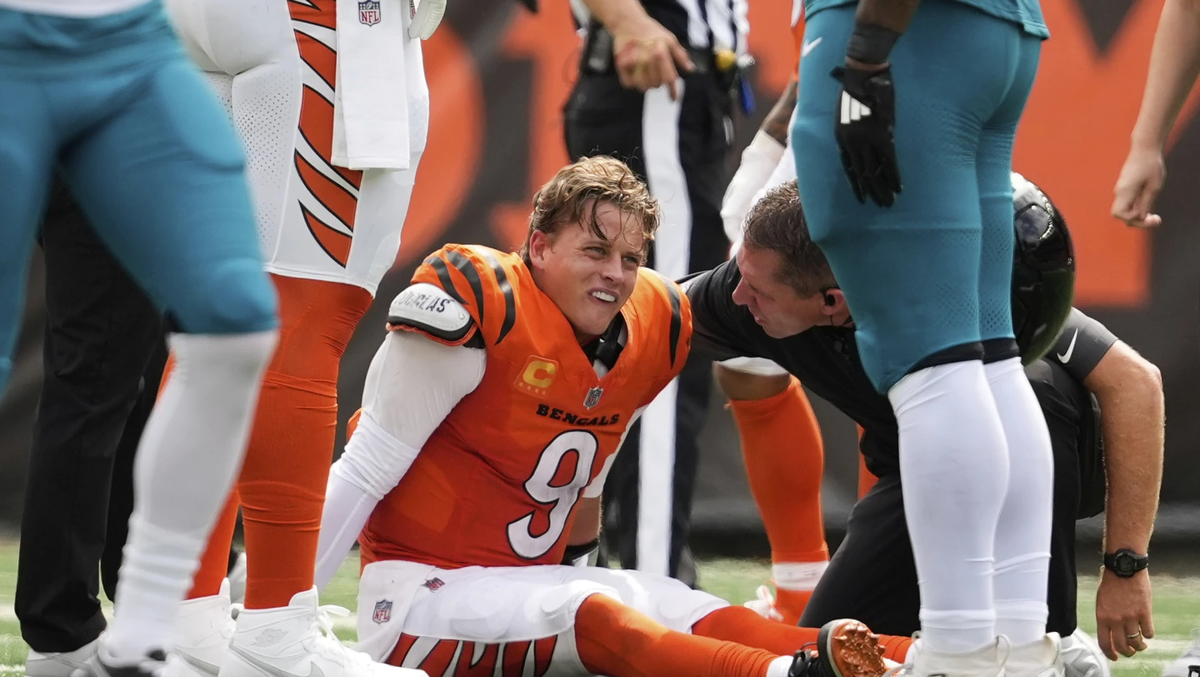Joe Burrow seen leaving Bengals locker room on crutch, with foot in boot after sustaining toe injury