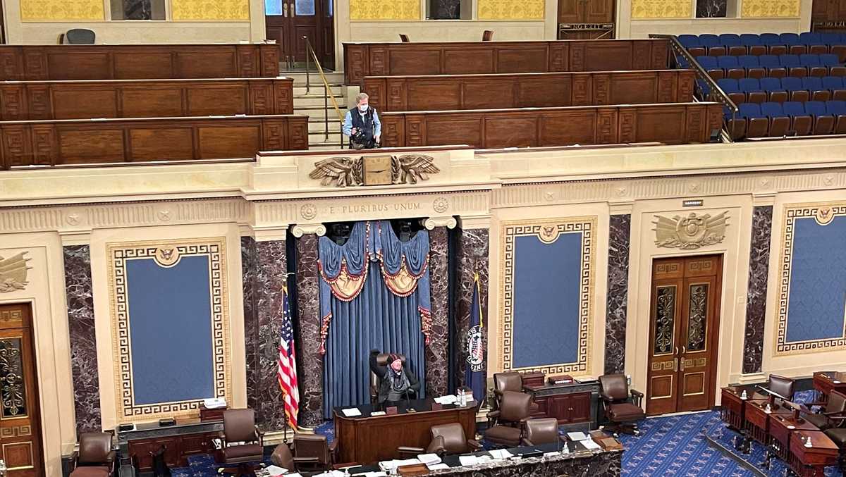 Man hanging off Senate balcony, sitting in vice president's chair ...