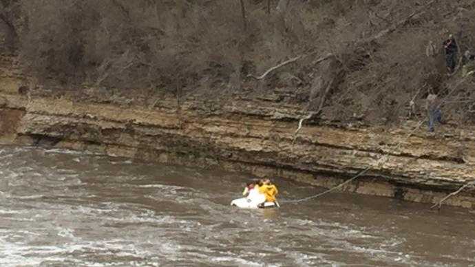 2 rescued after vehicle plunges into river