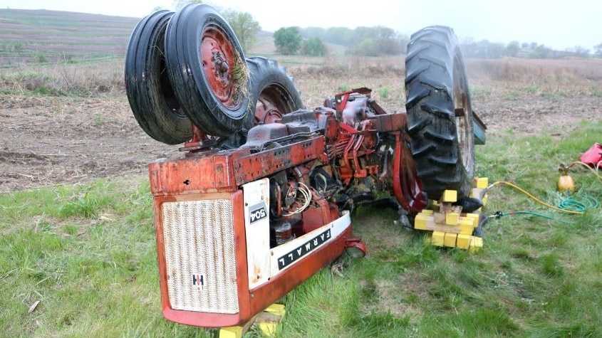 Firefighters pull man from underneath overturned tractor