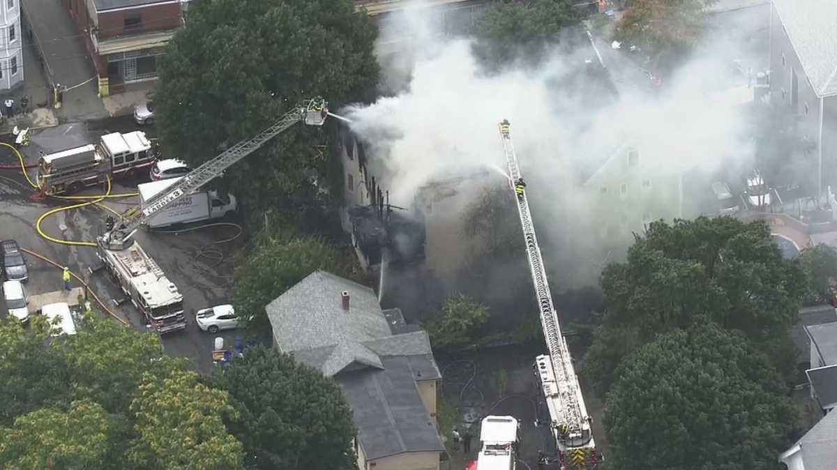 Firefighters battle triple-decker fire in Lawrence