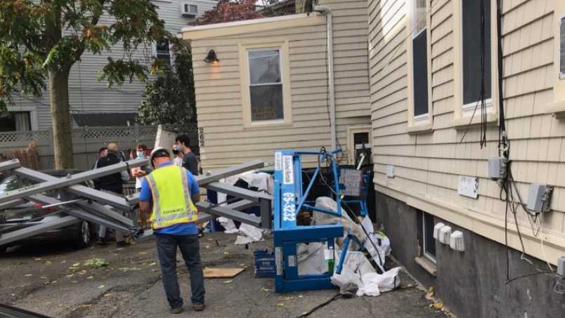 Lift tips over at job site, trapping 2 workers