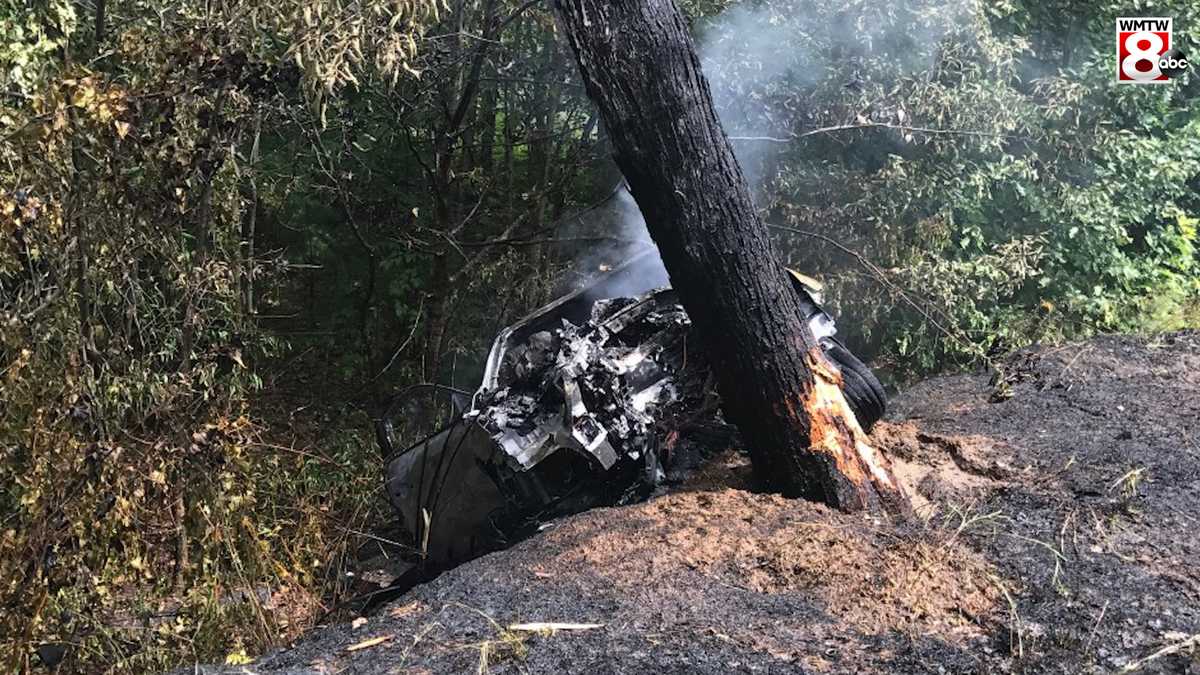 Woman rescued from burning car after crash