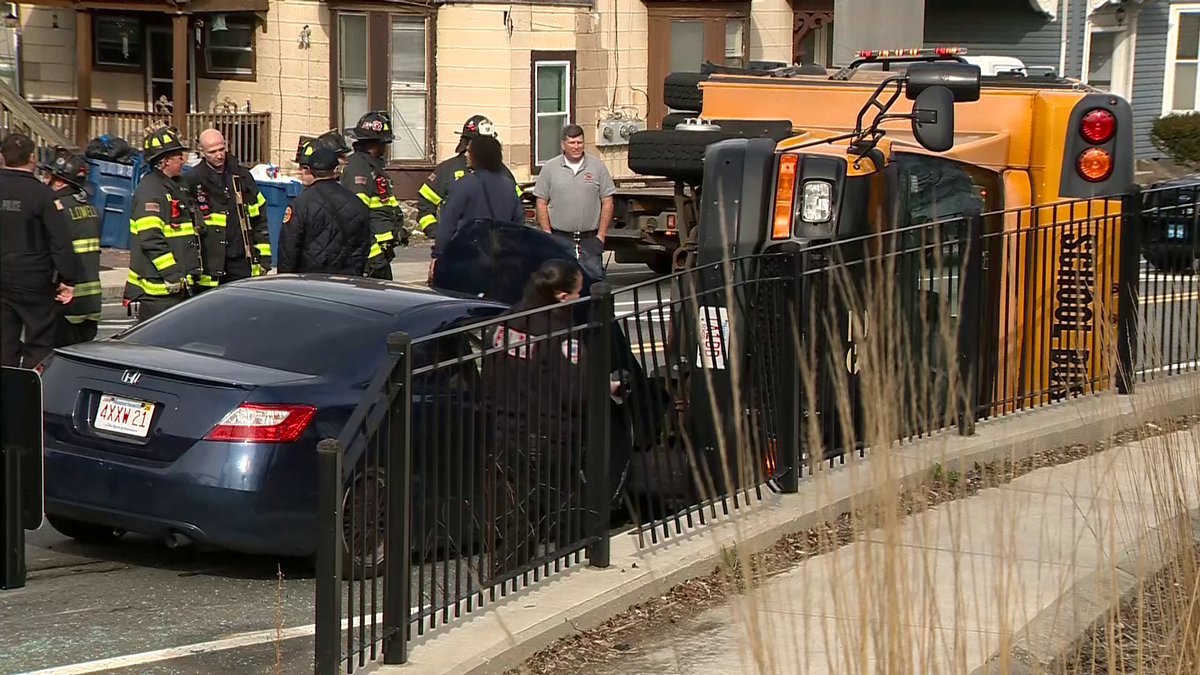 Crash leaves school bus on its side in Lowell, Massachusetts