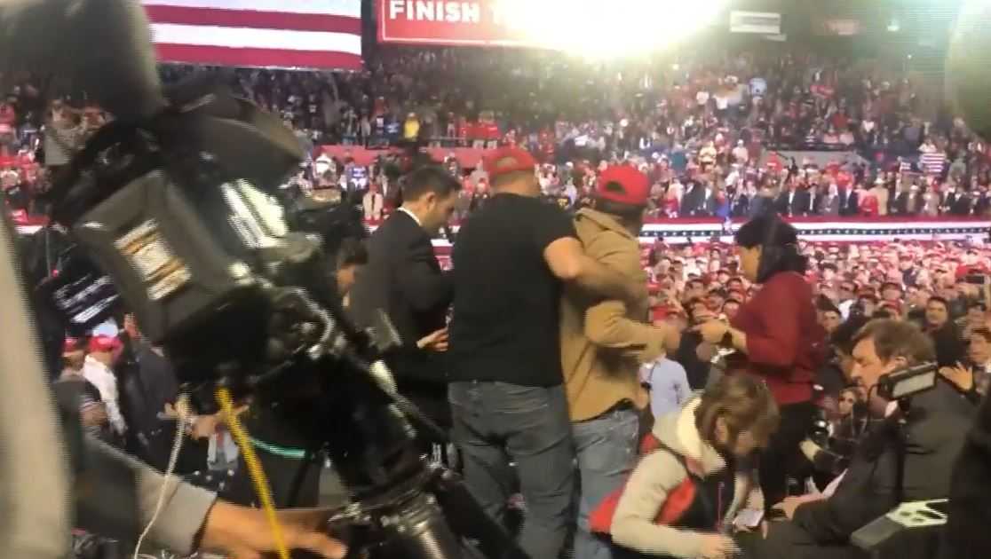 Man wearing MAGA hat shoves photographers during Trump rally in Texas